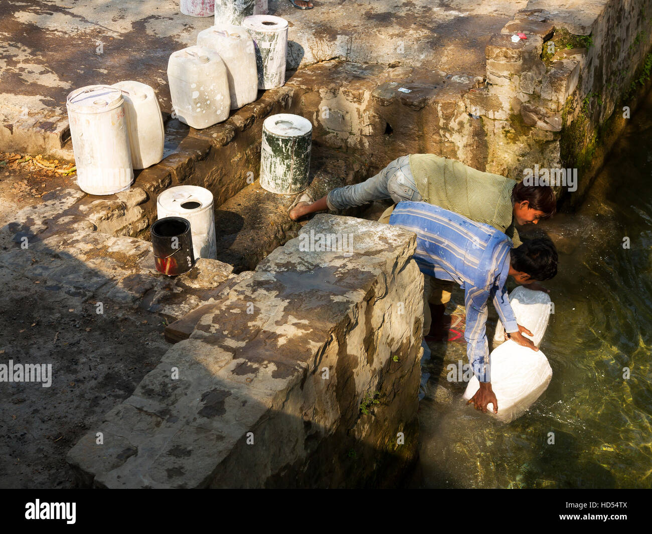 Indian boys fetching water at Boar Canal in the heat of the day at ...