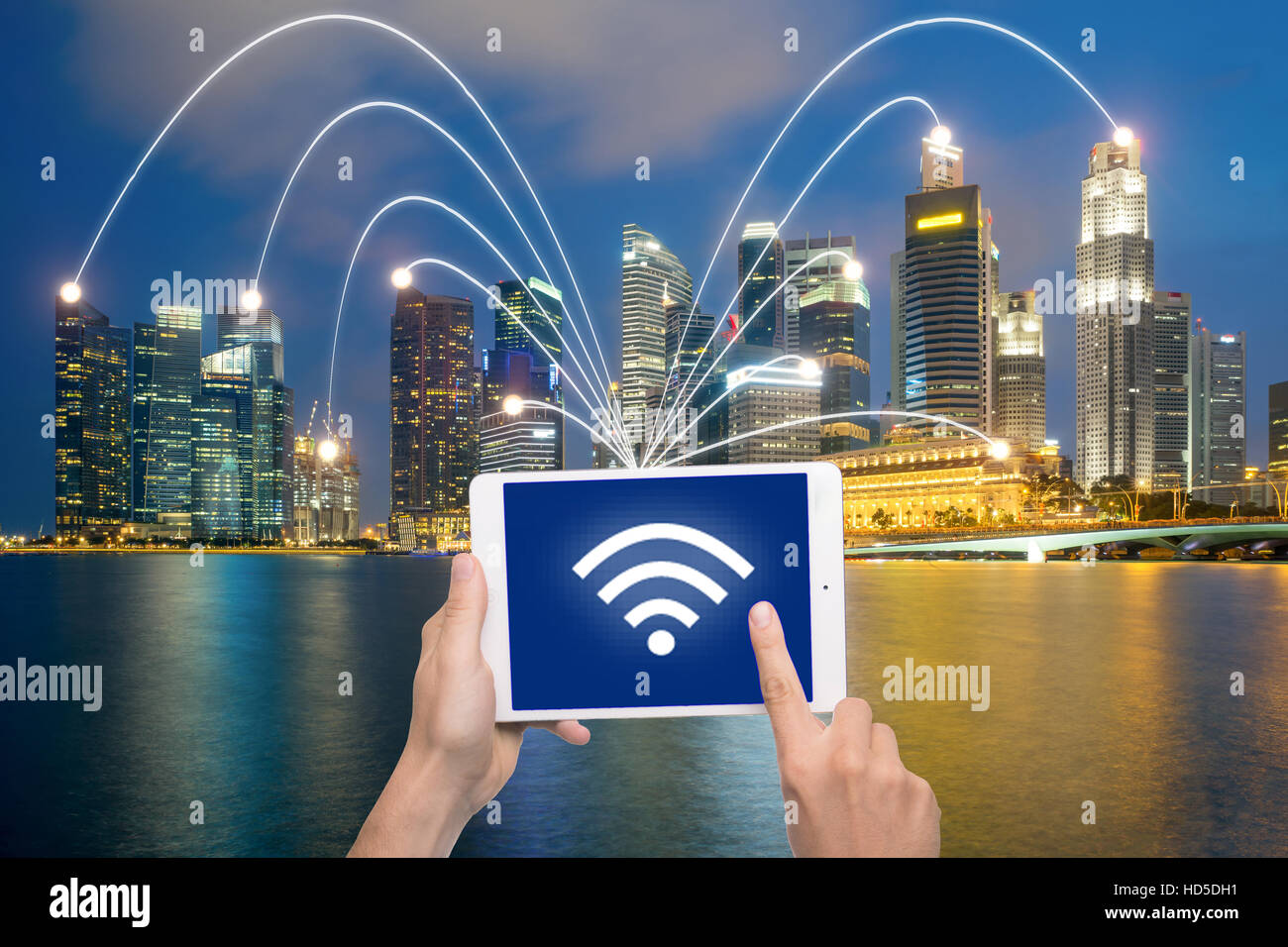 Hand holding digital tablet and Singapore city with network connection ...