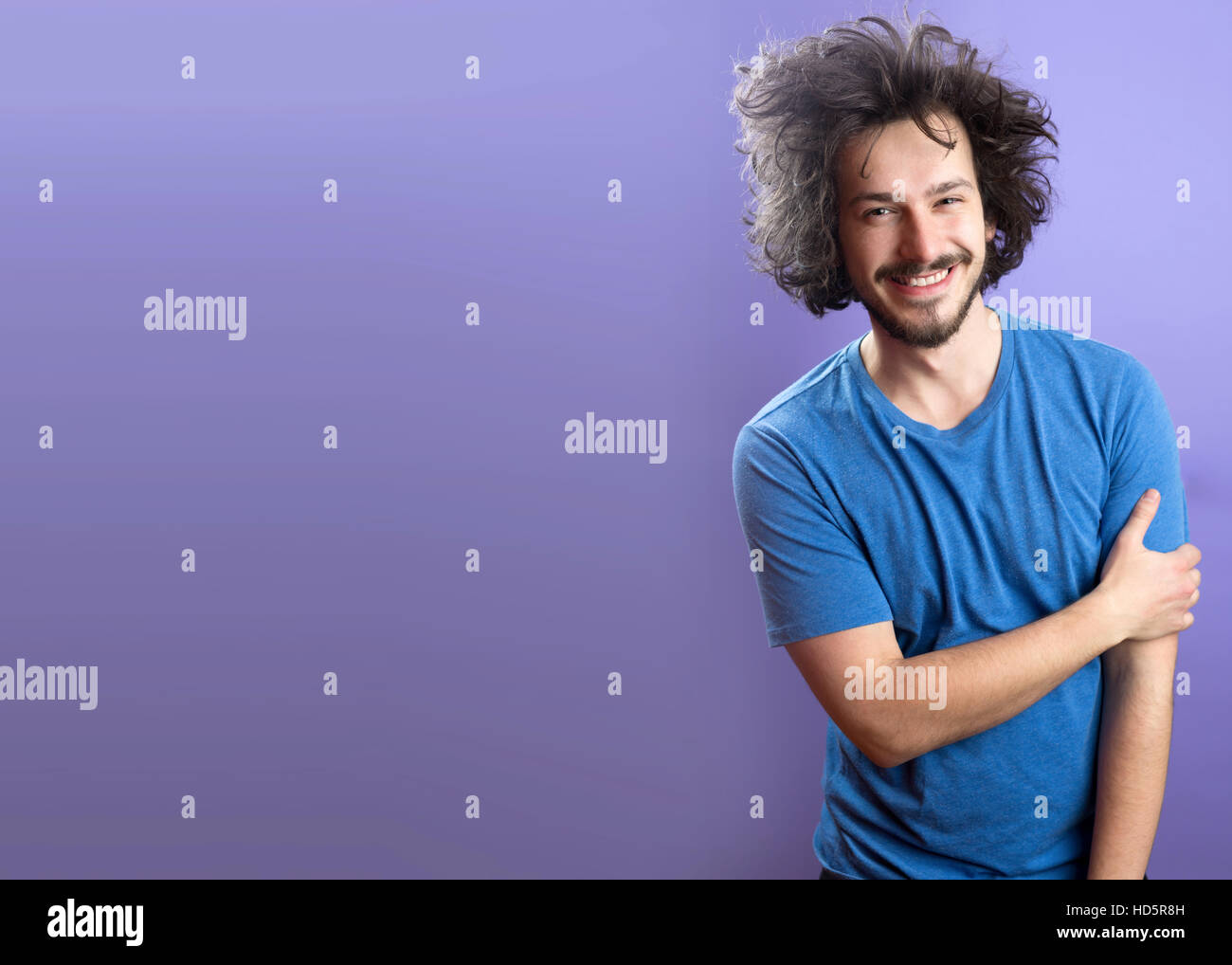 Beautiful man in front of a colored background Stock Photo - Alamy