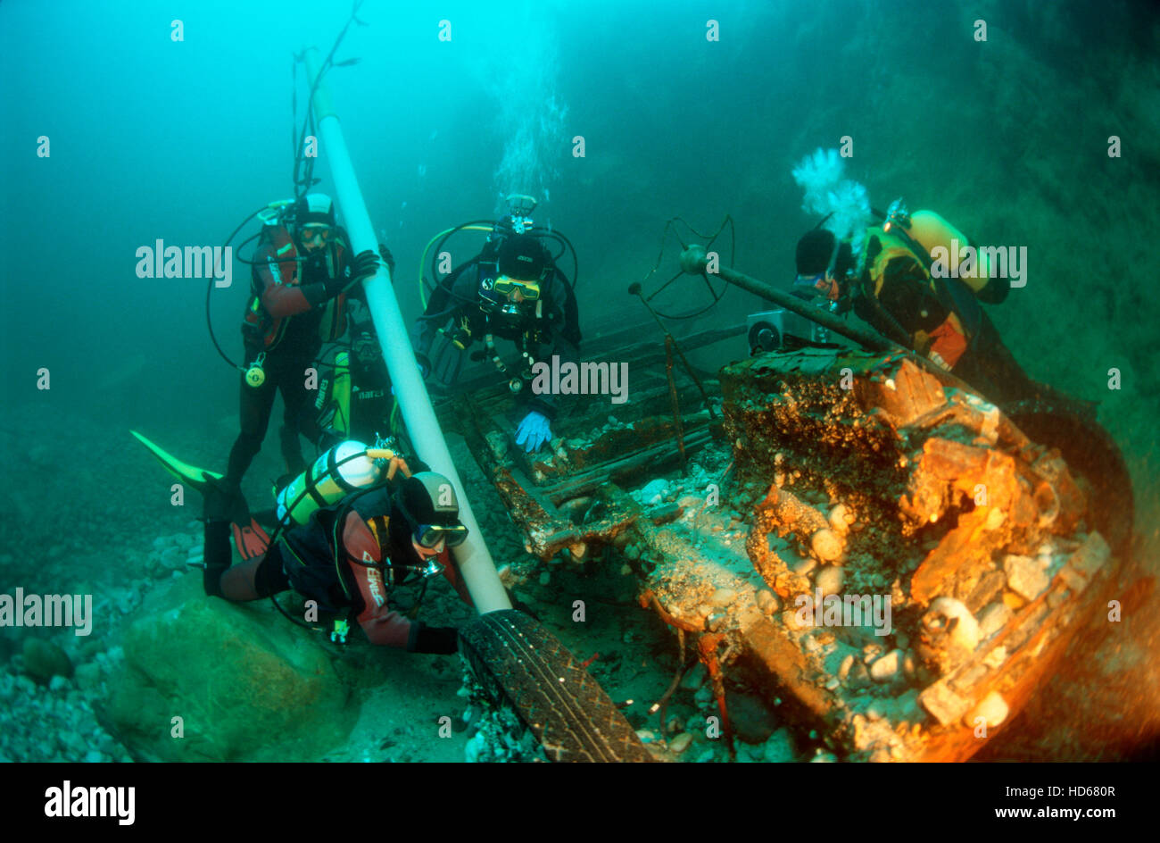 Scuba divers excavating a sunken truck from the 2nd World War in the ...