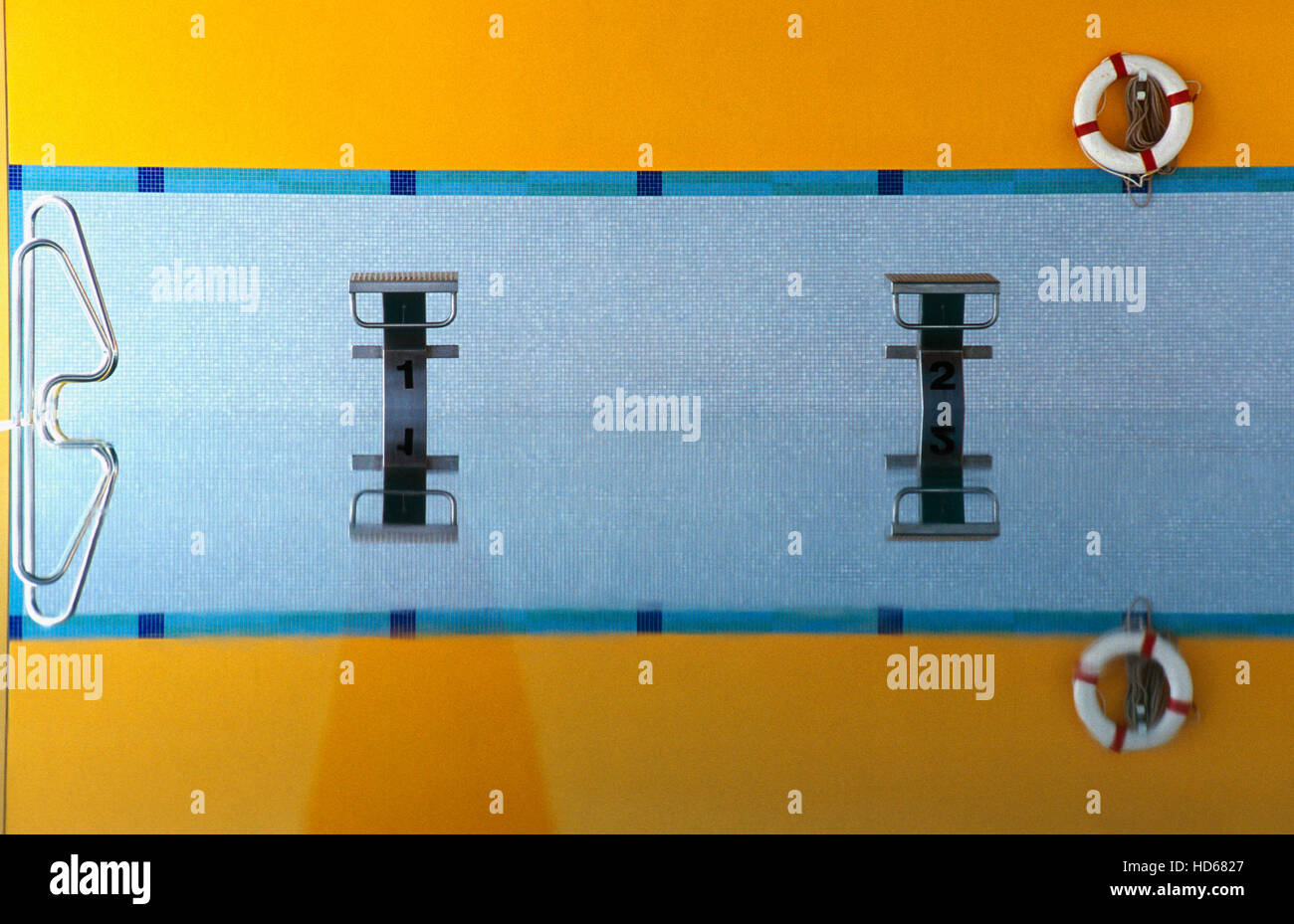 Starting blocks in a swimming pool with reflections in the water Stock ...