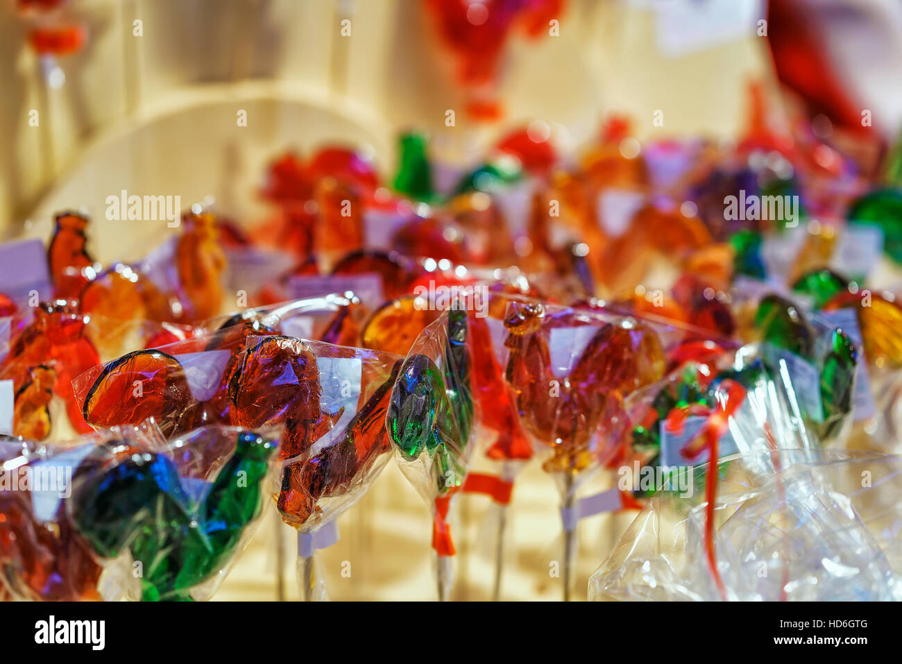 Stall with traditional colorful and festive lollipop in the form of hen ...