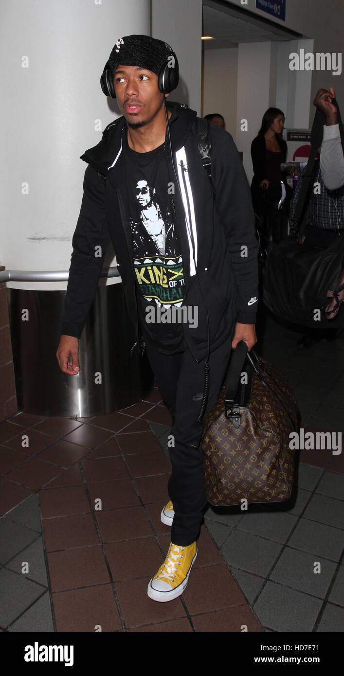 Nick Cannon arrives at Los Angeles International Airport carrying a ...