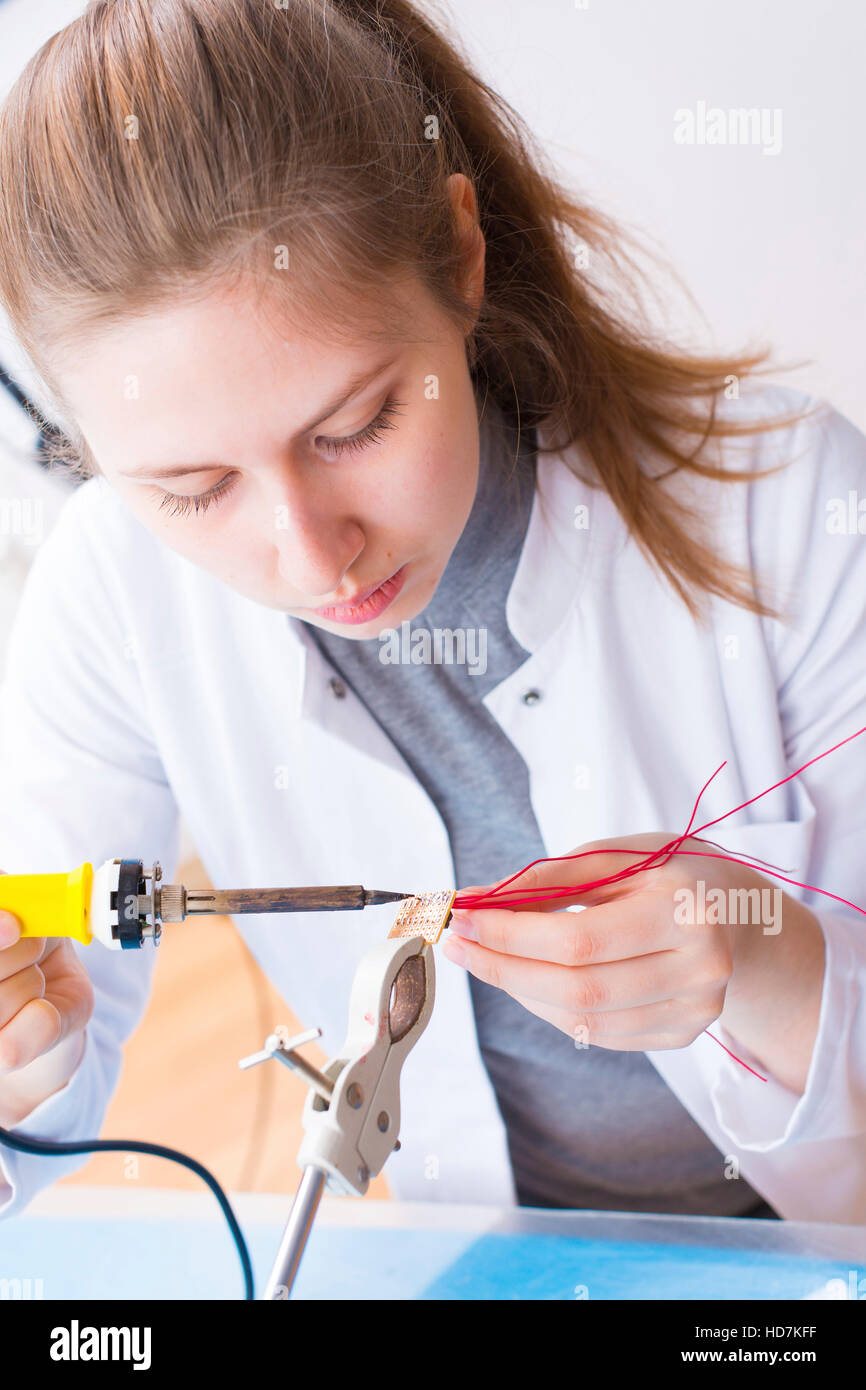 Female technician using soldering hi-res stock photography and images ...