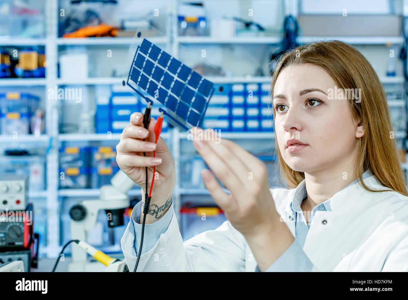 MODEL RELEASED. Girl holding film solar cells Stock Photo - Alamy