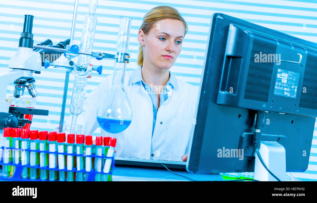 MODEL RELEASED. Woman using computer in chemical laboratory Stock Photo ...