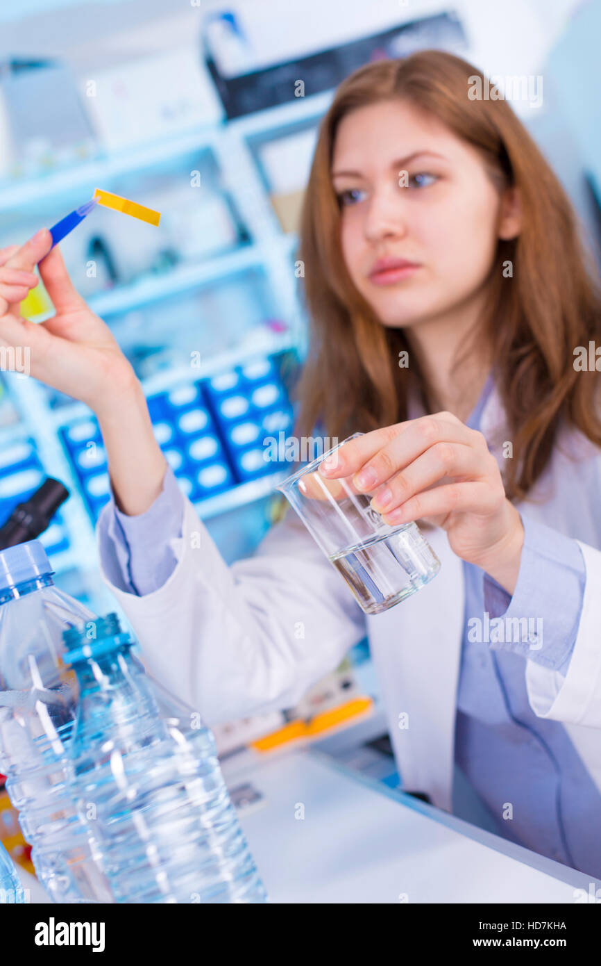 MODEL RELEASED. Woman testing water in laboratory Stock Photo - Alamy