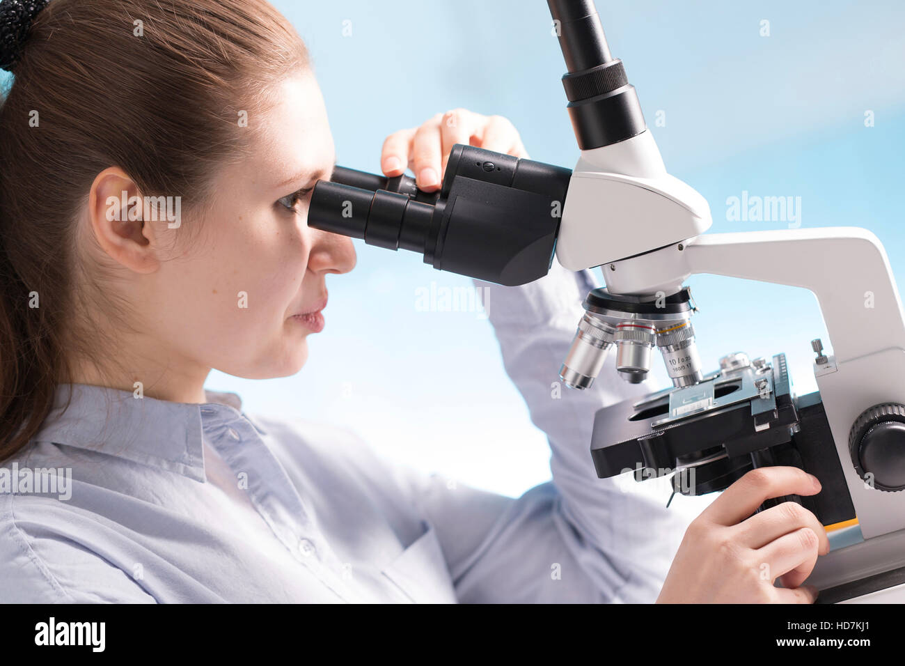 MODEL RELEASED. Woman using microscope Stock Photo - Alamy