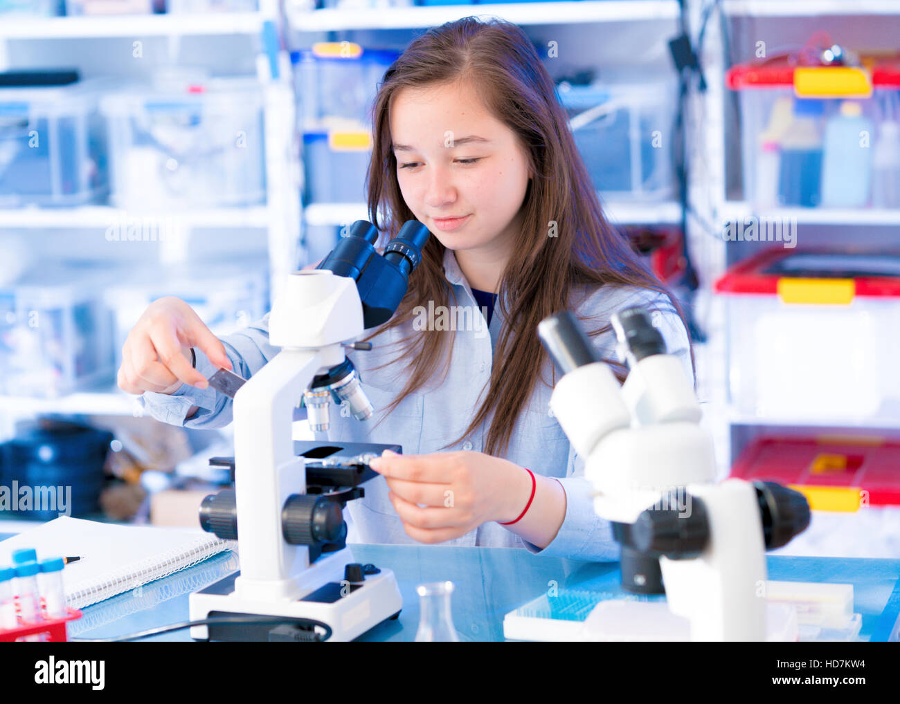 MODEL RELEASED. Girl using microscope in laboratory Stock Photo - Alamy