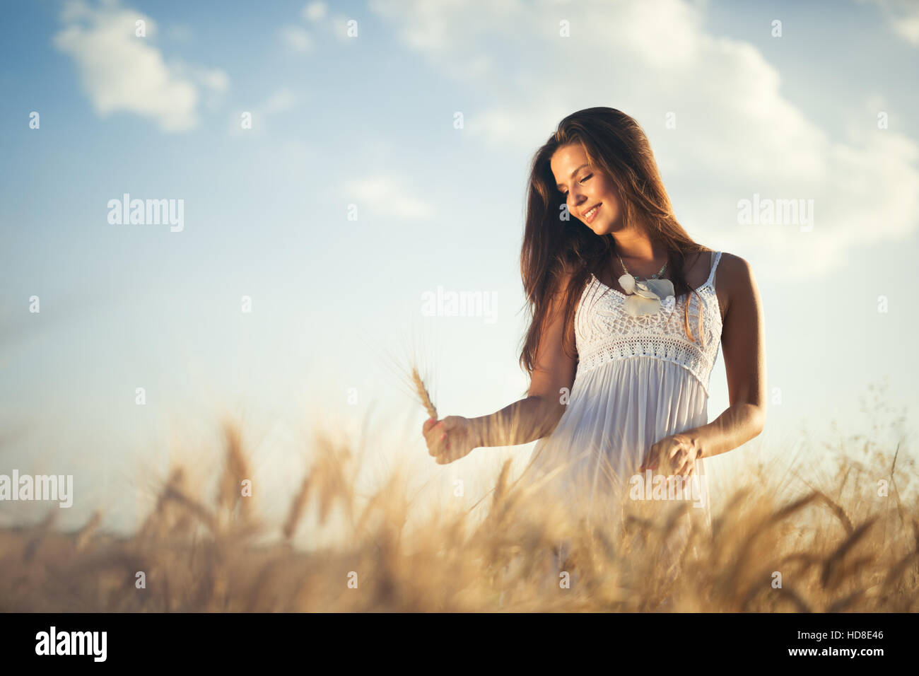 Beautiful carefree woman in wheat meadow Stock Photo - Alamy