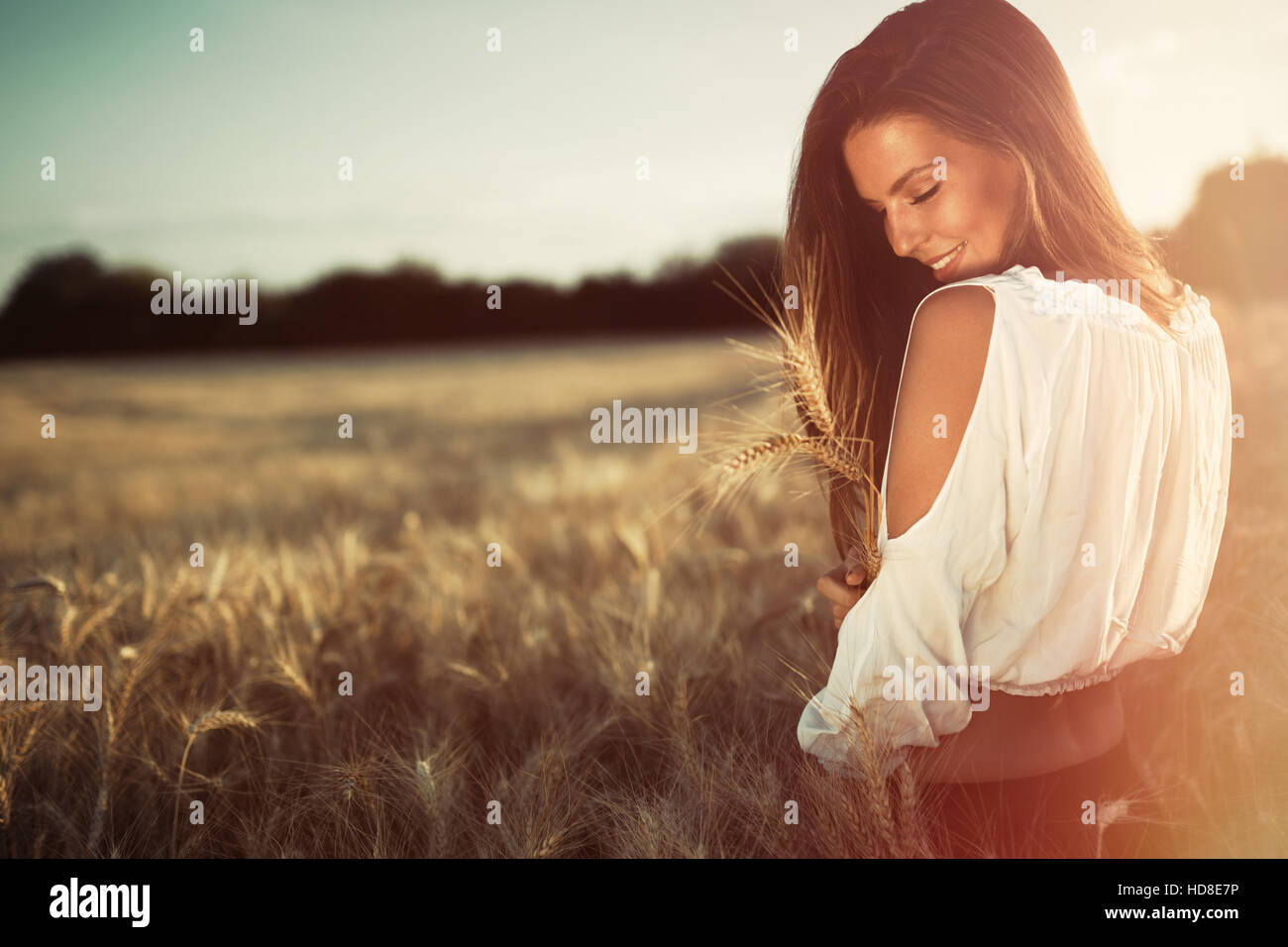 Beautiful carefree woman in wheat meadow Stock Photo - Alamy