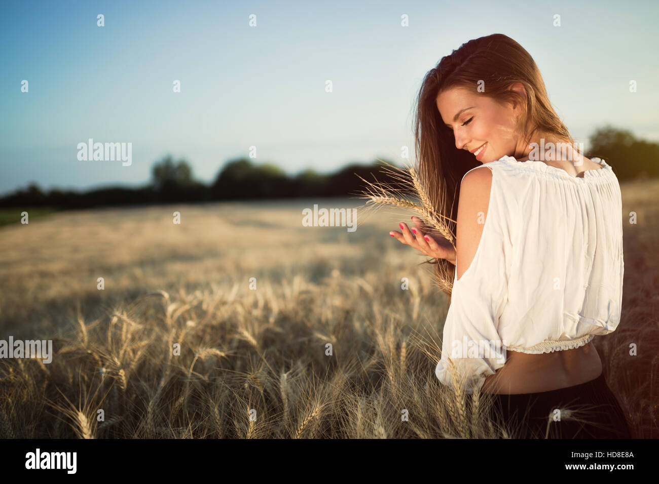 Beautiful carefree woman in wheat meadow Stock Photo - Alamy