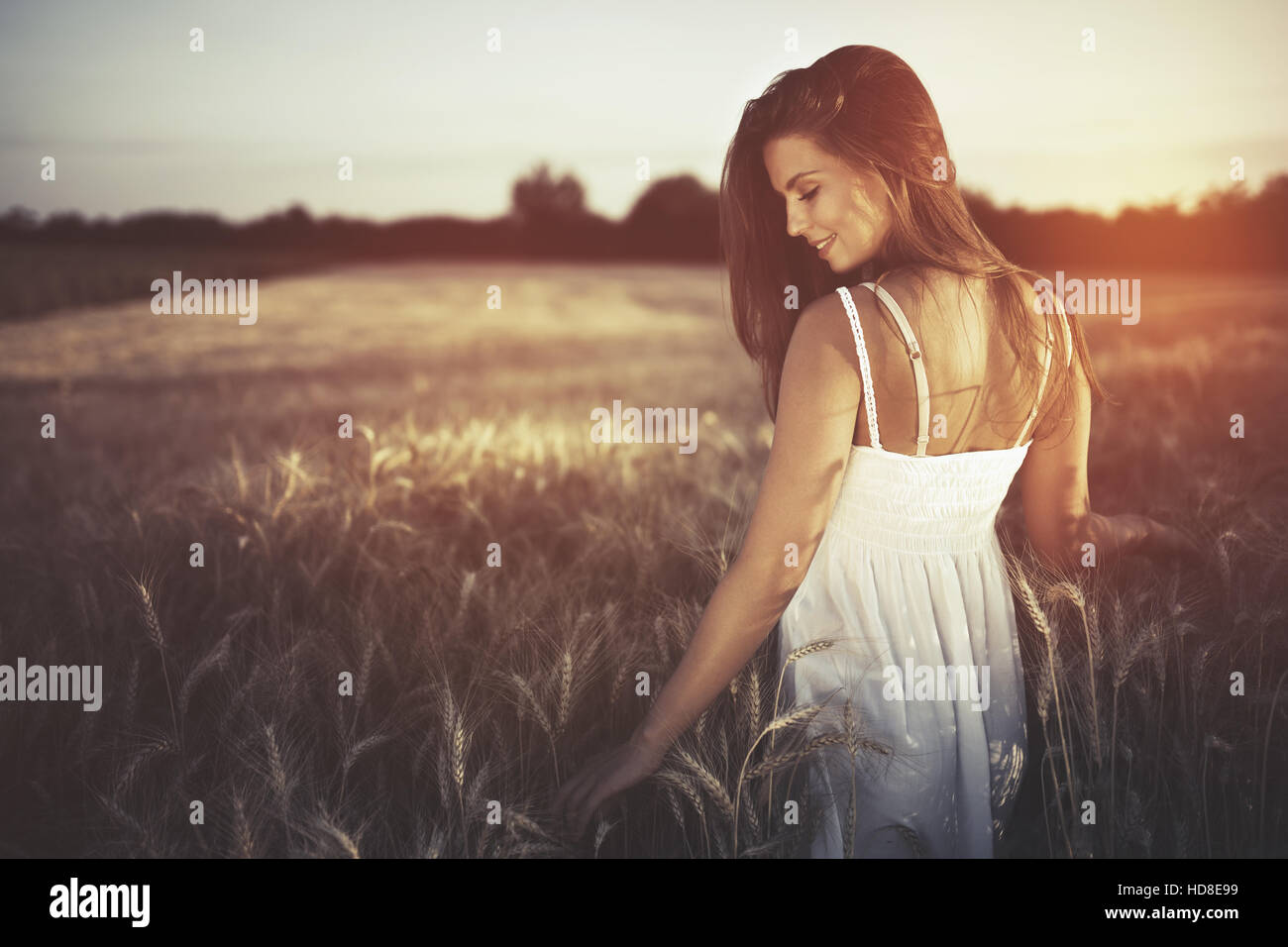 Beautiful carefree woman in wheat meadow Stock Photo - Alamy