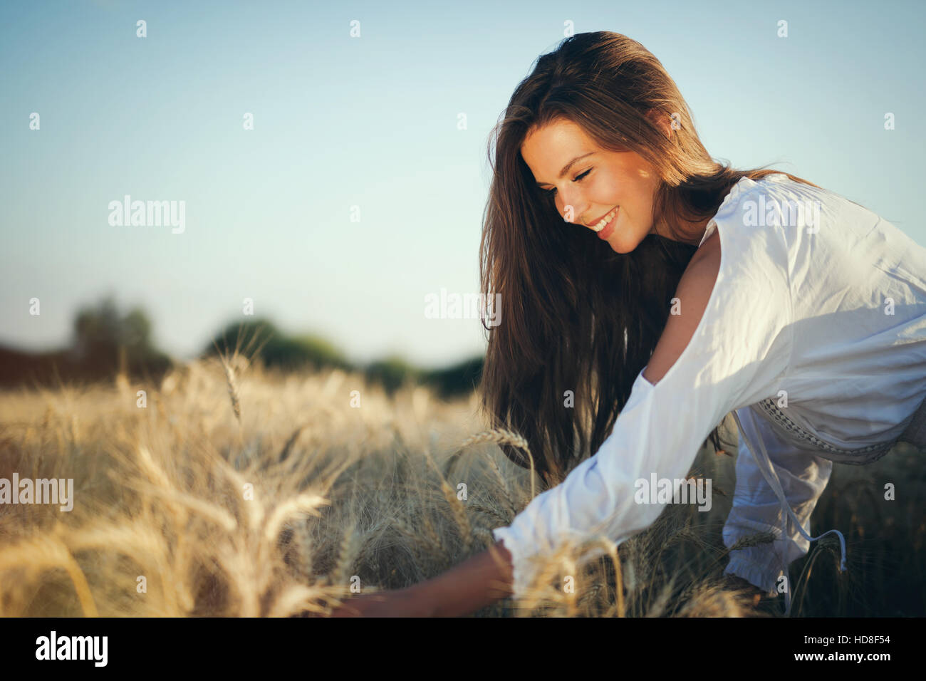 Beautiful carefree woman in wheat meadow Stock Photo - Alamy