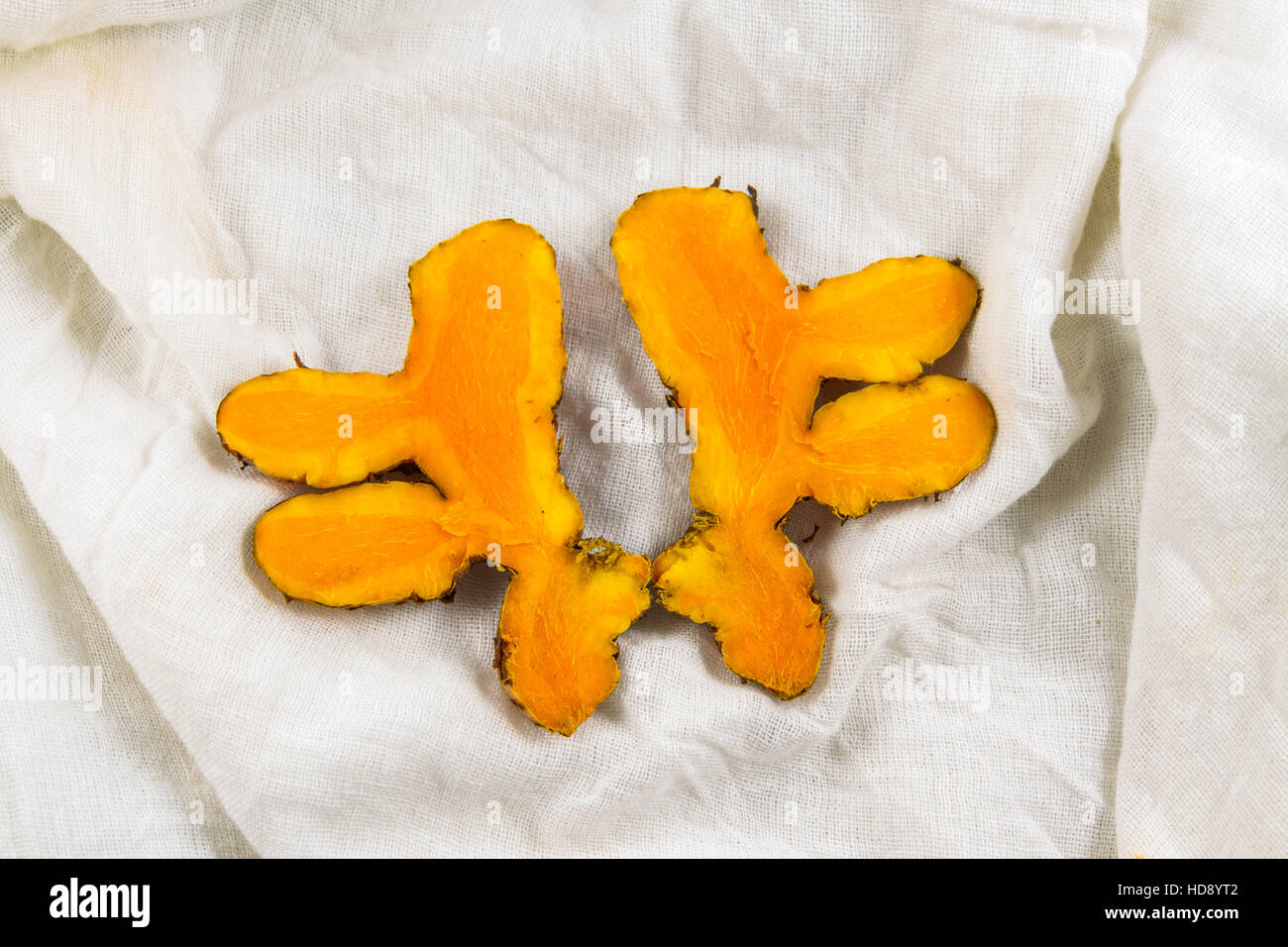 Piece sliced and two halves shown of turmeric or Curcuma longa root on ... Piece sliced and two halves shown of turmeric or Curcuma longa root on ...