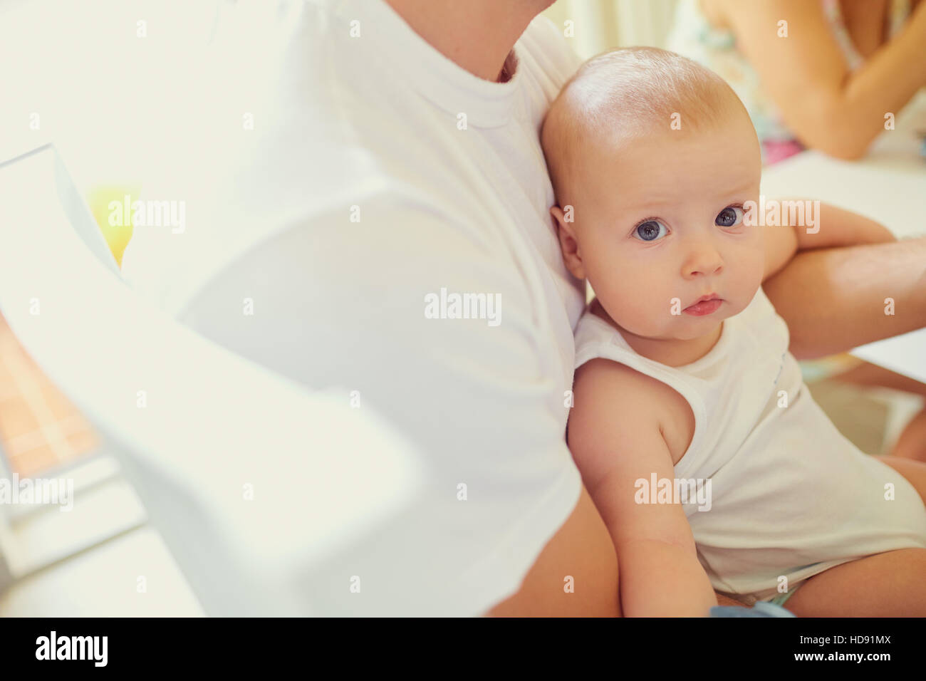 Boy baby in the arms of his father looking at the camera Stock Photo ...
