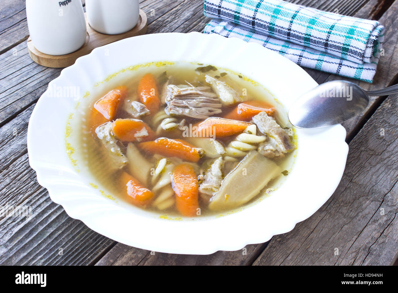 Beef and vegetable broth soup on wooden table Stock Photo - Alamy