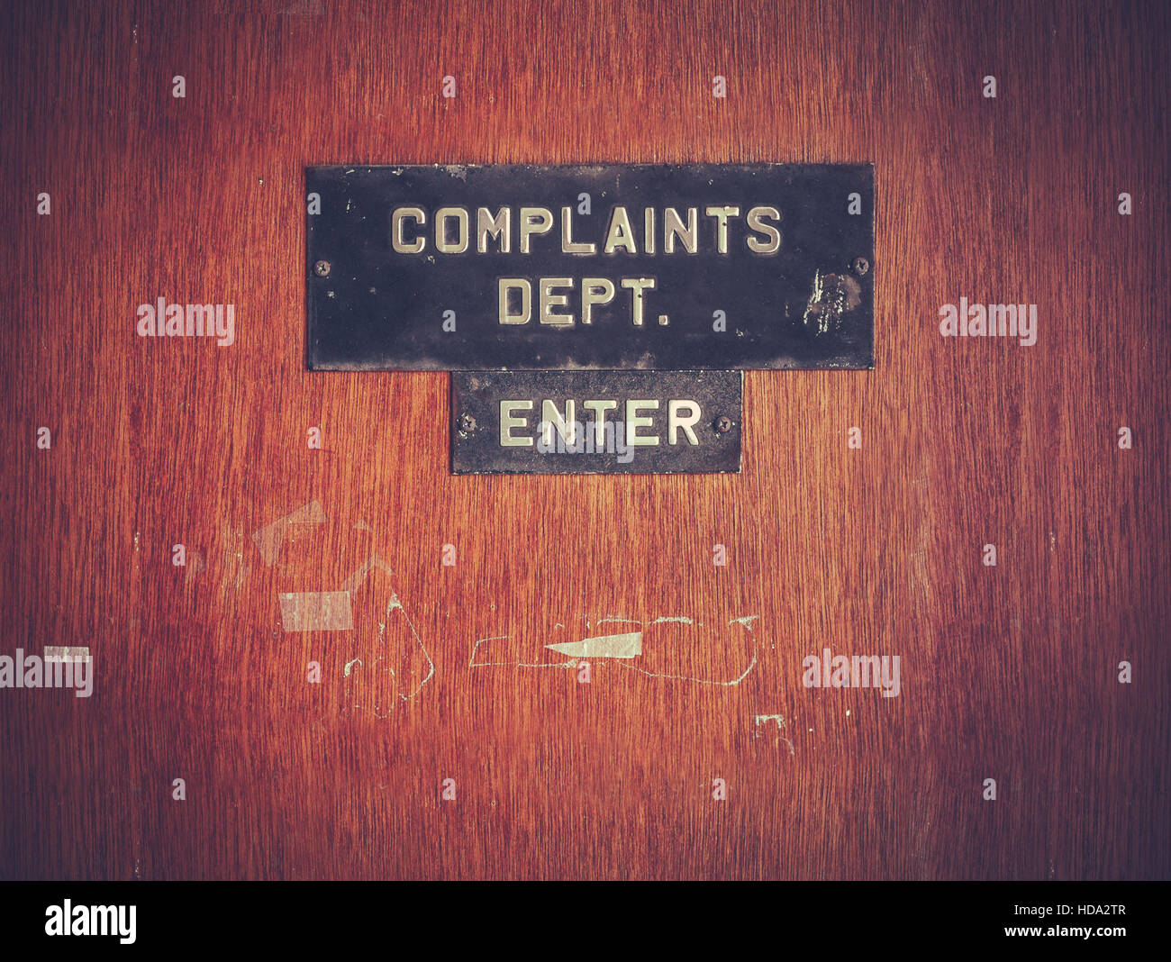 A Grungy Complaints Department Sign On A Door Stock Photo - Alamy