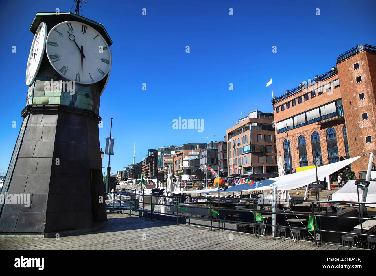 Clock tower on Aker Brygge Dock and modern building in Oslo, Norway ...