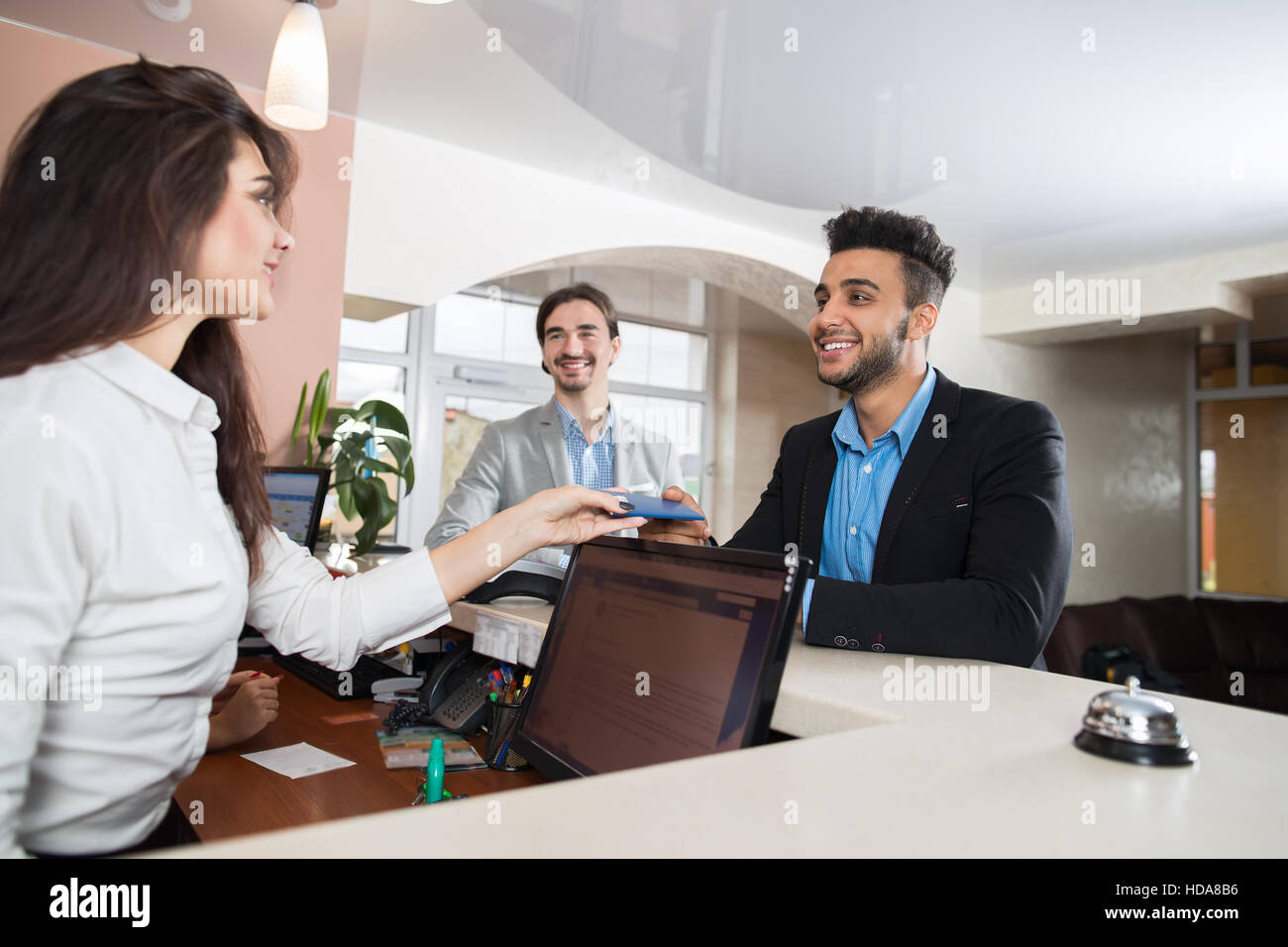 Two Business Man Arriving To Hotel Give Meeting Woman Receptionist ...
