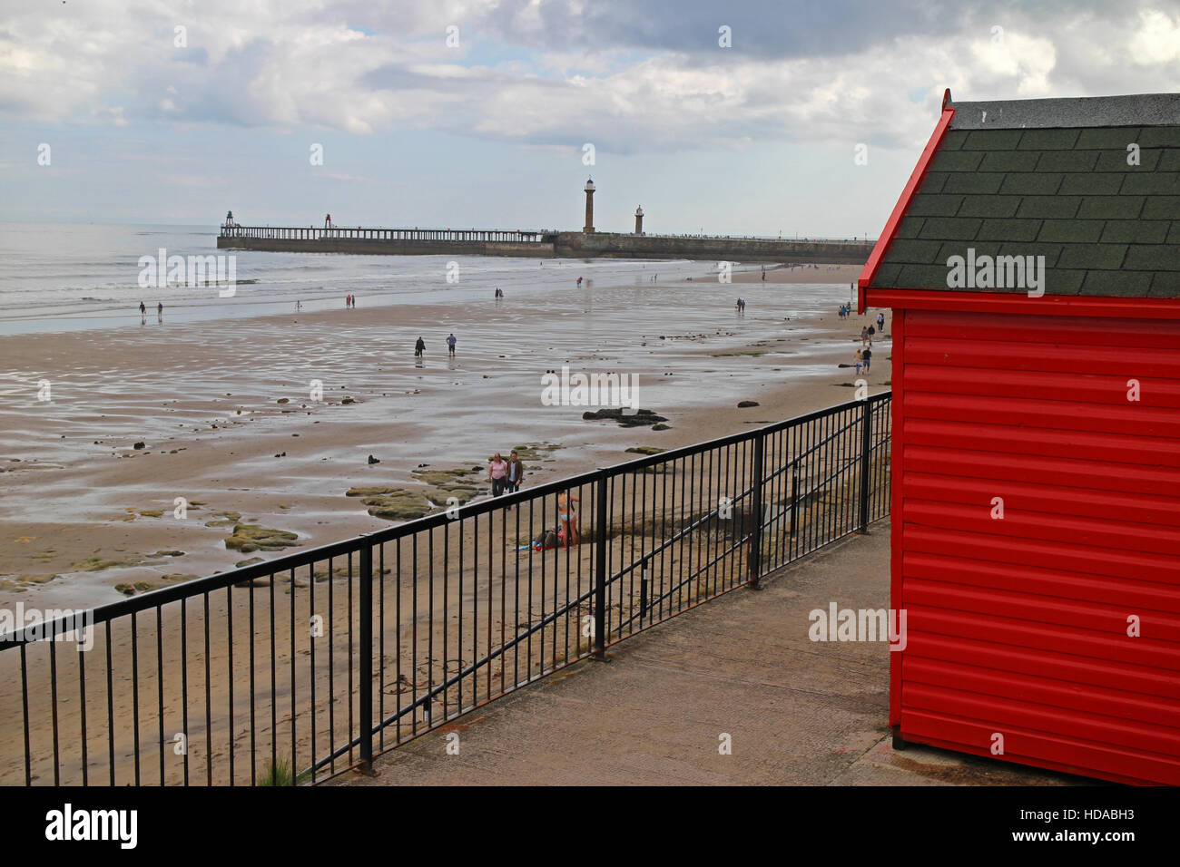 The beach and Coloured beach hut on Whitby promenade Stock Photo - Alamy