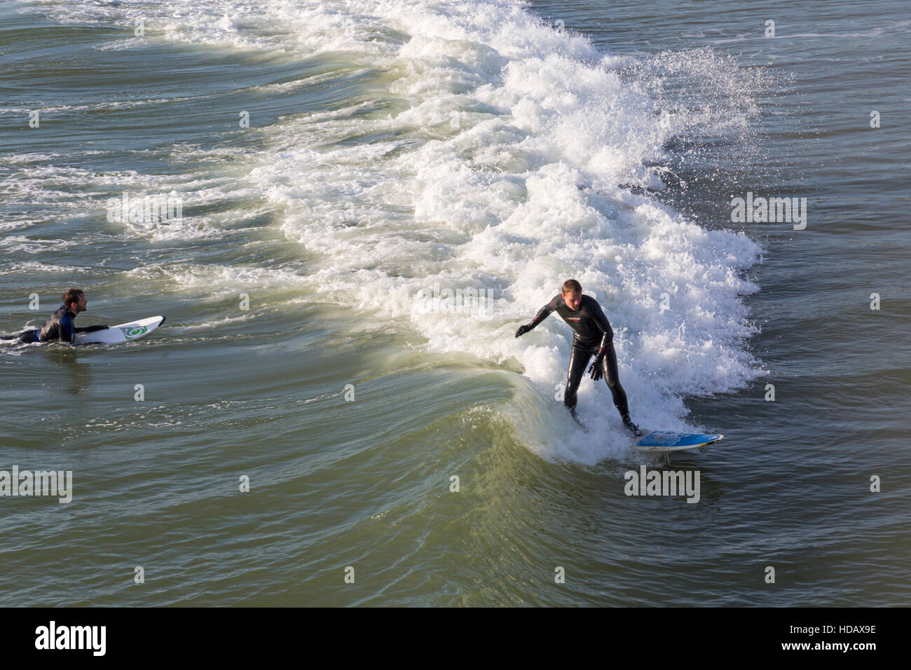 Bournemouth, Dorset, UK 11 December 2016. Surfer riding a wave, surfers ...