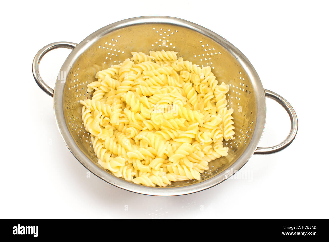 Fresh cooked fusilli pasta in strainer isolated on white Stock Photo ...