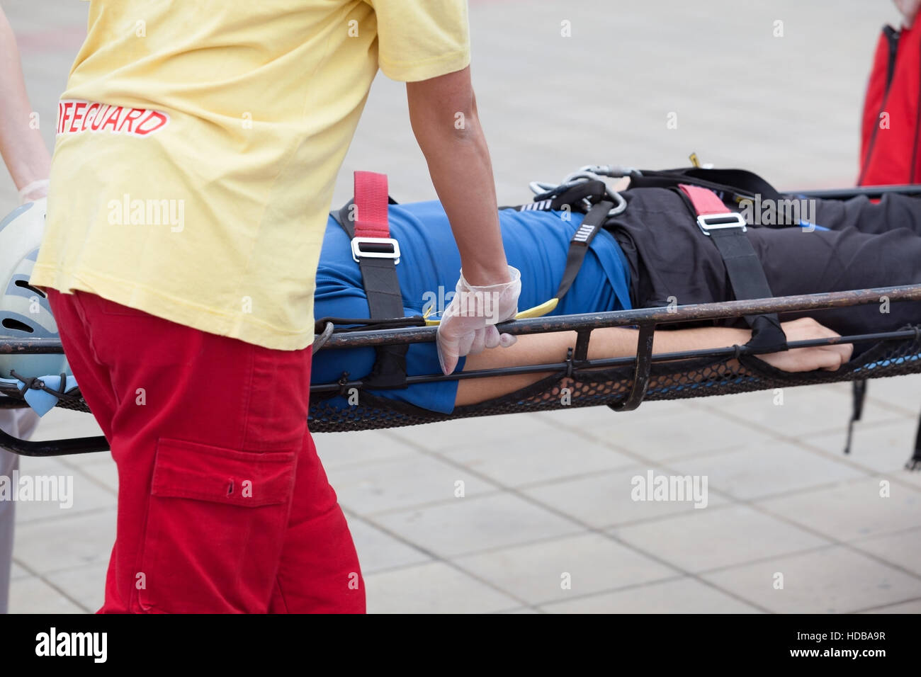 Paramedics carrying stretcher injured in hi-res stock photography and ...