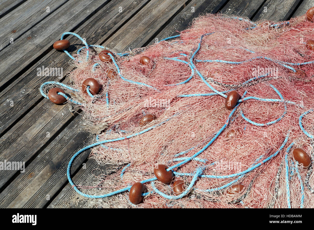 Orange rope fishing nets on a wooden pier Stock Photo - Alamy