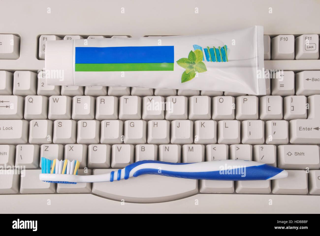 Computer keyboard, toothpaste and toothbrushes. Gray color Stock Photo ...