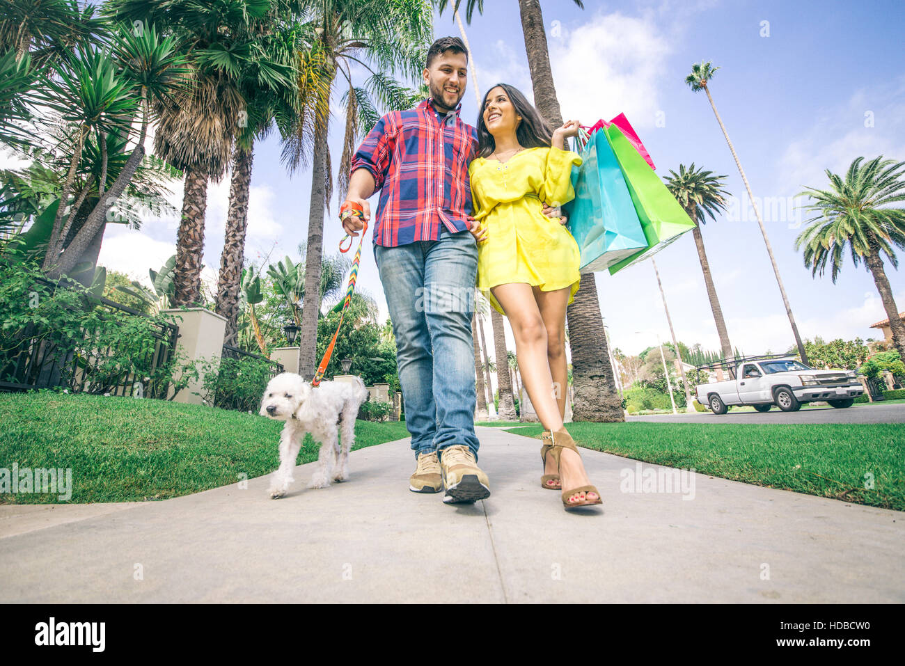 Happy couple laughing and walking while shopping - Boyfriend with ...