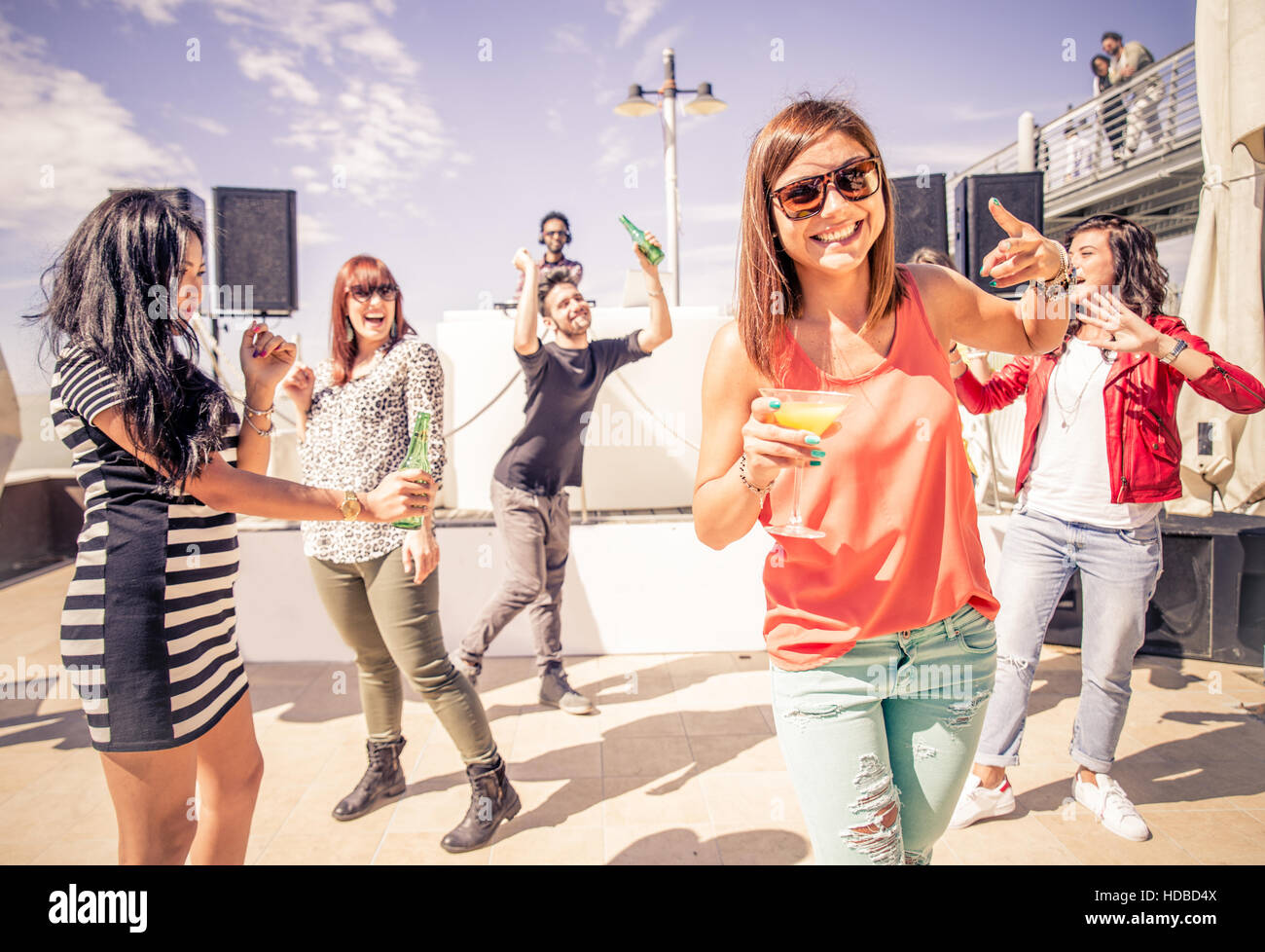 Portrait of happy friends dancing at party - Cool people drinking ...