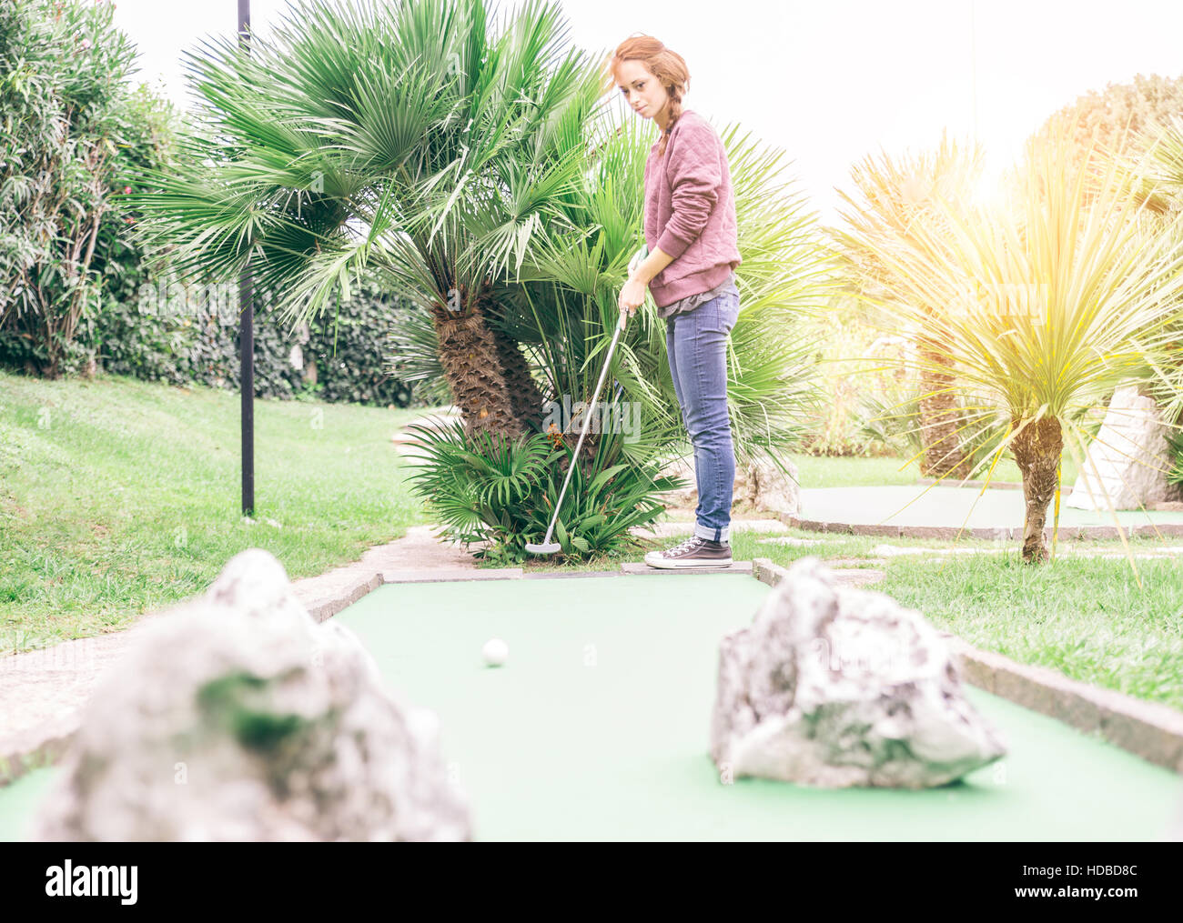 Active young woman playing minigolf in a amusement park Stock Photo - Alamy
