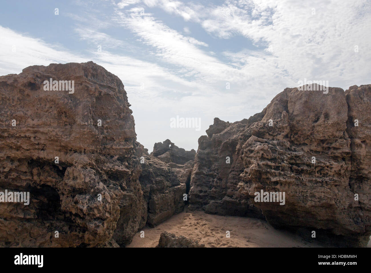 Close up of Large formation of rocks on shoreline between beach and ...