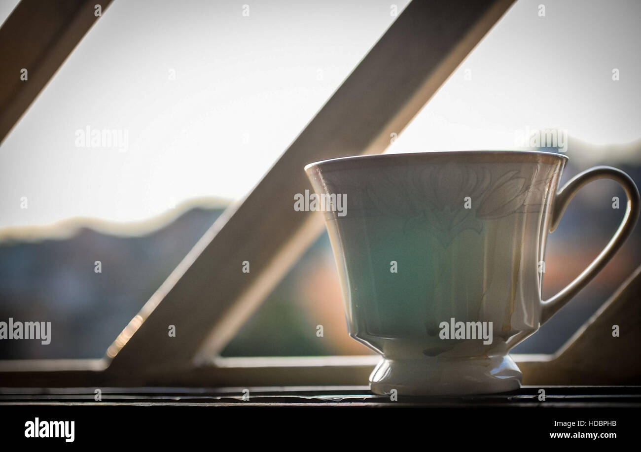 Cup photographed over open window, backlit Stock Photo - Alamy