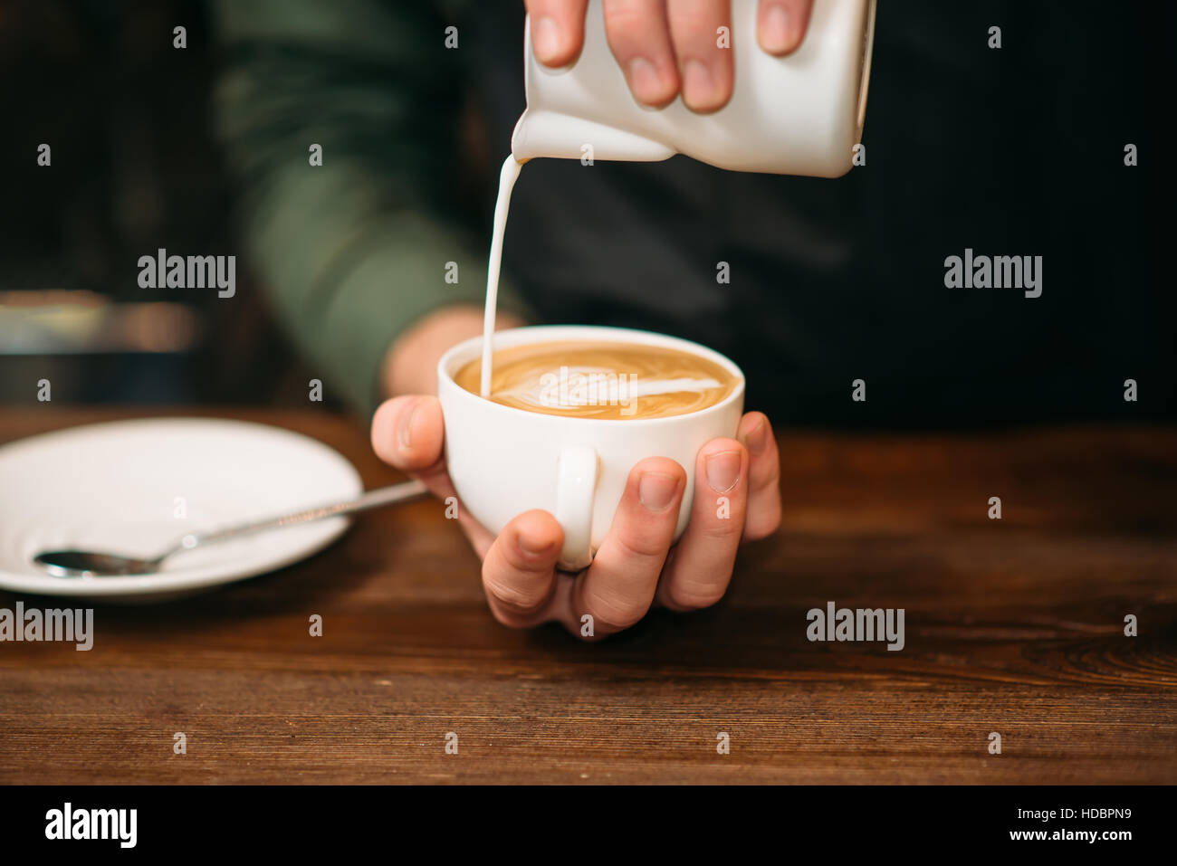 Man hands adding cream coffee hi-res stock photography and images - Alamy