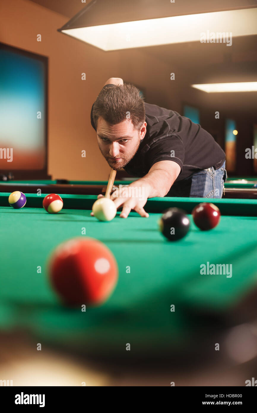 Focused man beats a billiard ball Stock Photo - Alamy