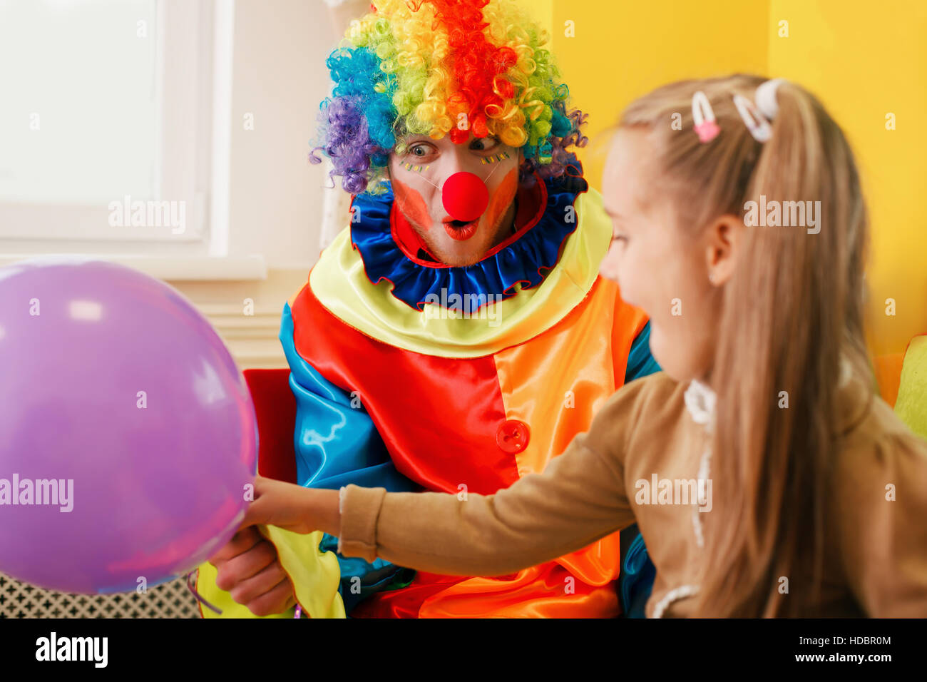 Amusing clown give air balloon to the little girl Stock Photo - Alamy