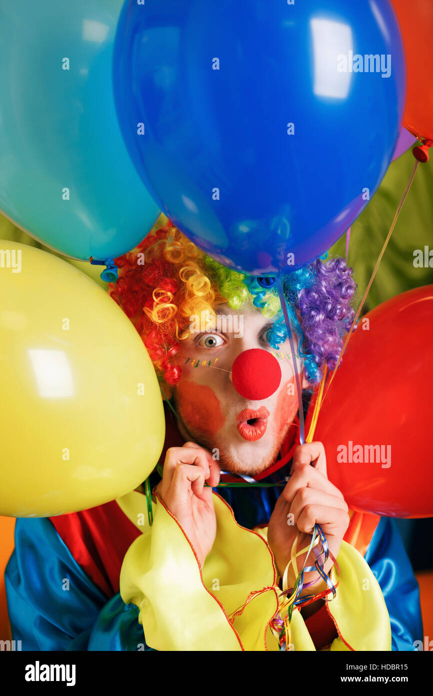 Clown with a bunch of colorful air balloons Stock Photo - Alamy