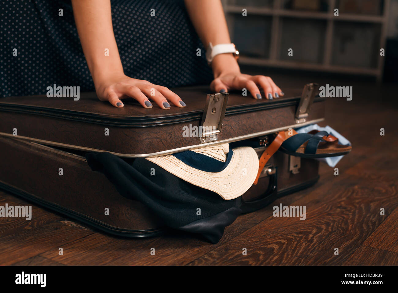 Woman closing luggage hi-res stock photography and images - Alamy