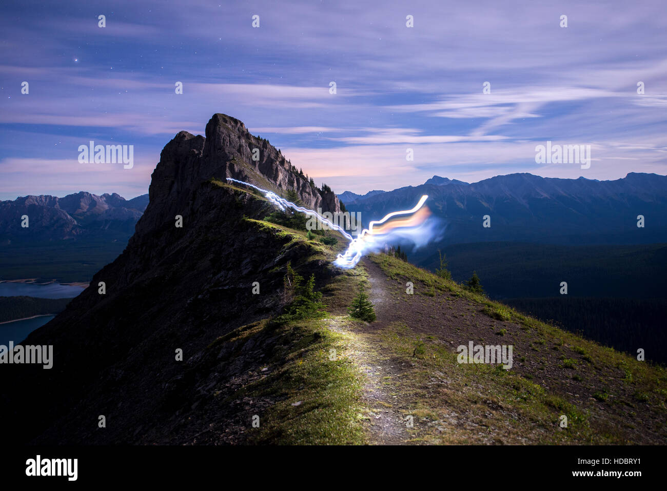 Light trail running along ridge of mountain at night Stock Photo - Alamy