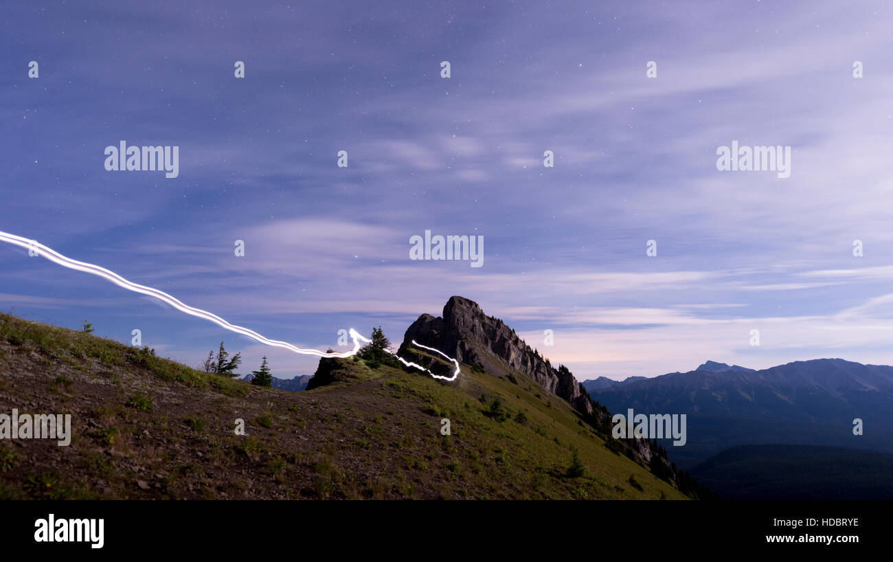 Light trail running along ridge of mountain at night Stock Photo - Alamy