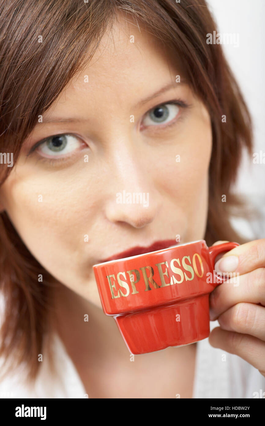 Woman drinking an espresso Stock Photo - Alamy
