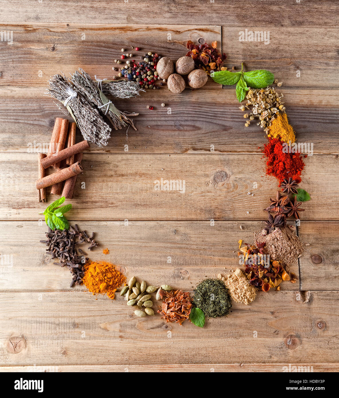 Wooden table with a colorful display border of spices and herbs Stock ...