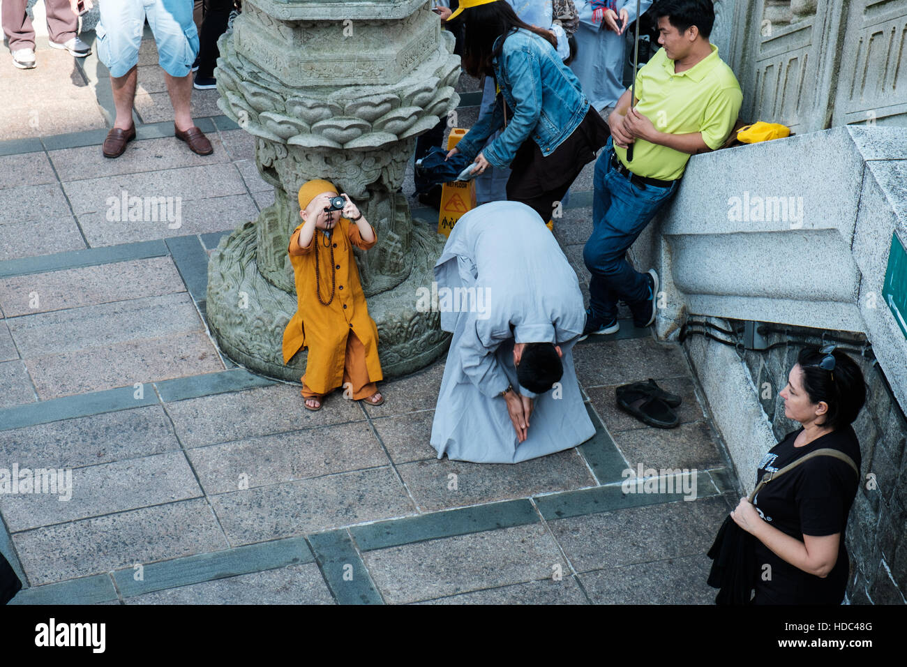 American flag raised on a flag pole with negative space and blue sky ...