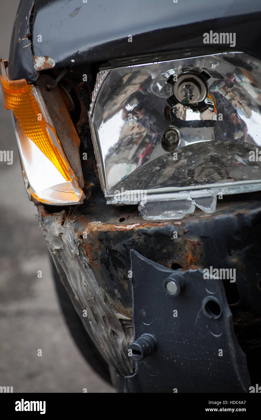 Color image of a crashed car with broken headlight Stock Photo - Alamy