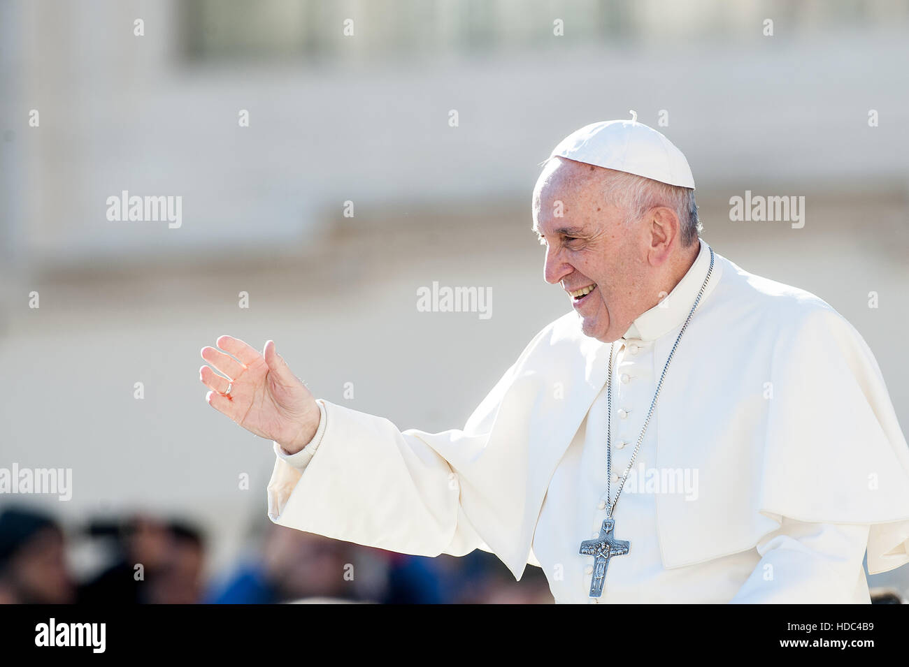 Pope Francis waves as he is driven across the crowd ahead of his weekly ...