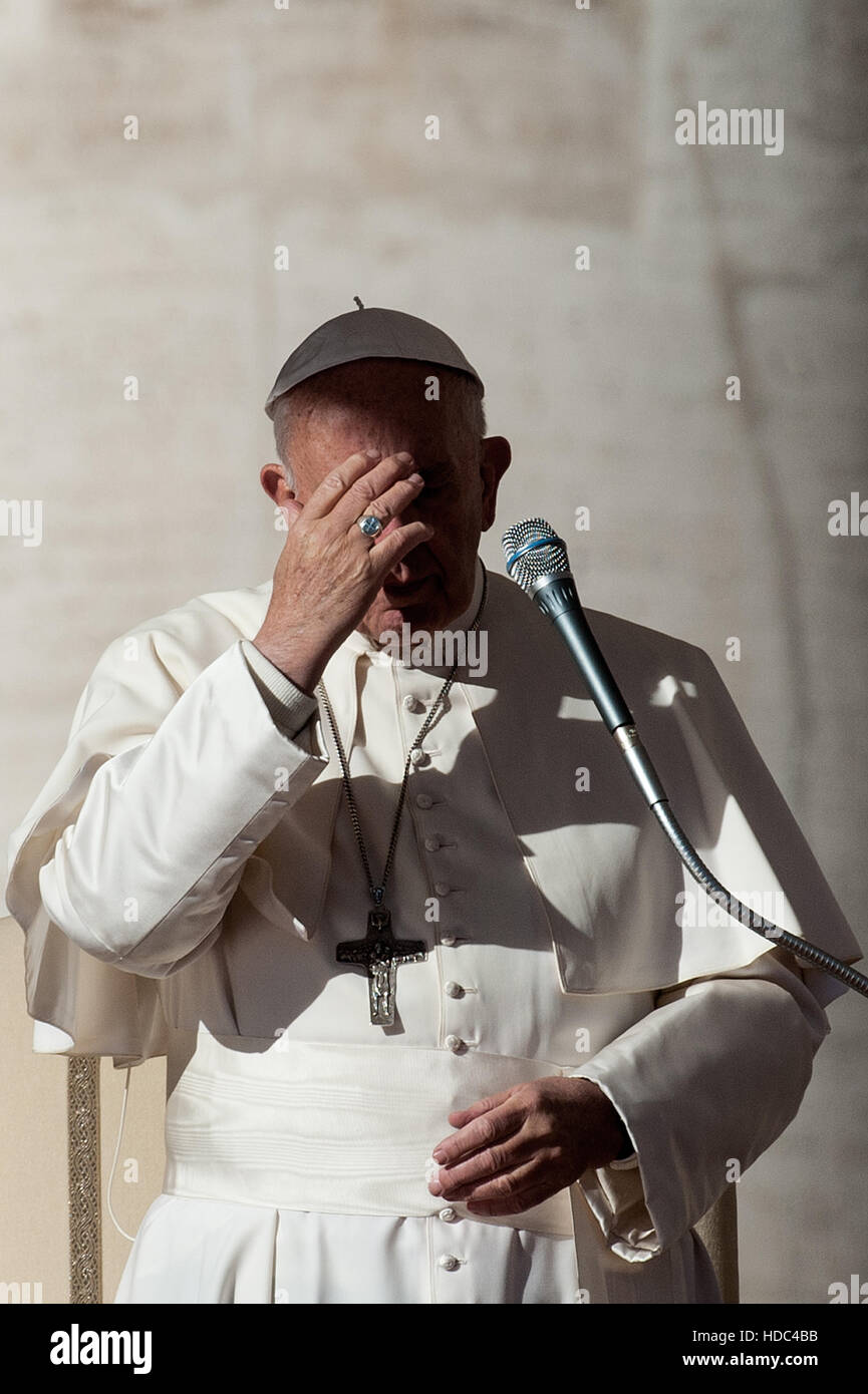 Pope Francis waves as he is driven across the crowd ahead of his weekly ...