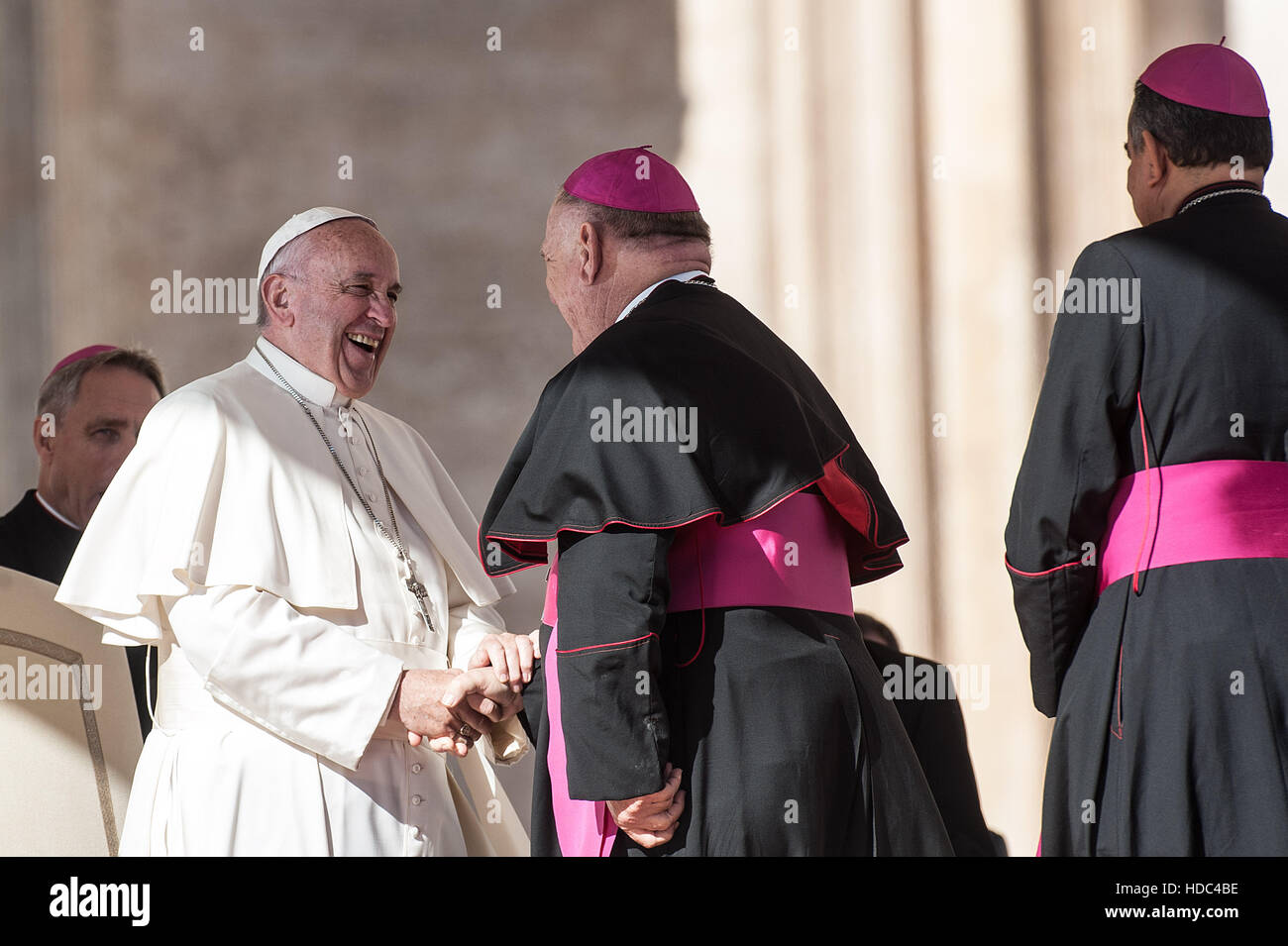 Pope Francis waves as he is driven across the crowd ahead of his weekly ...