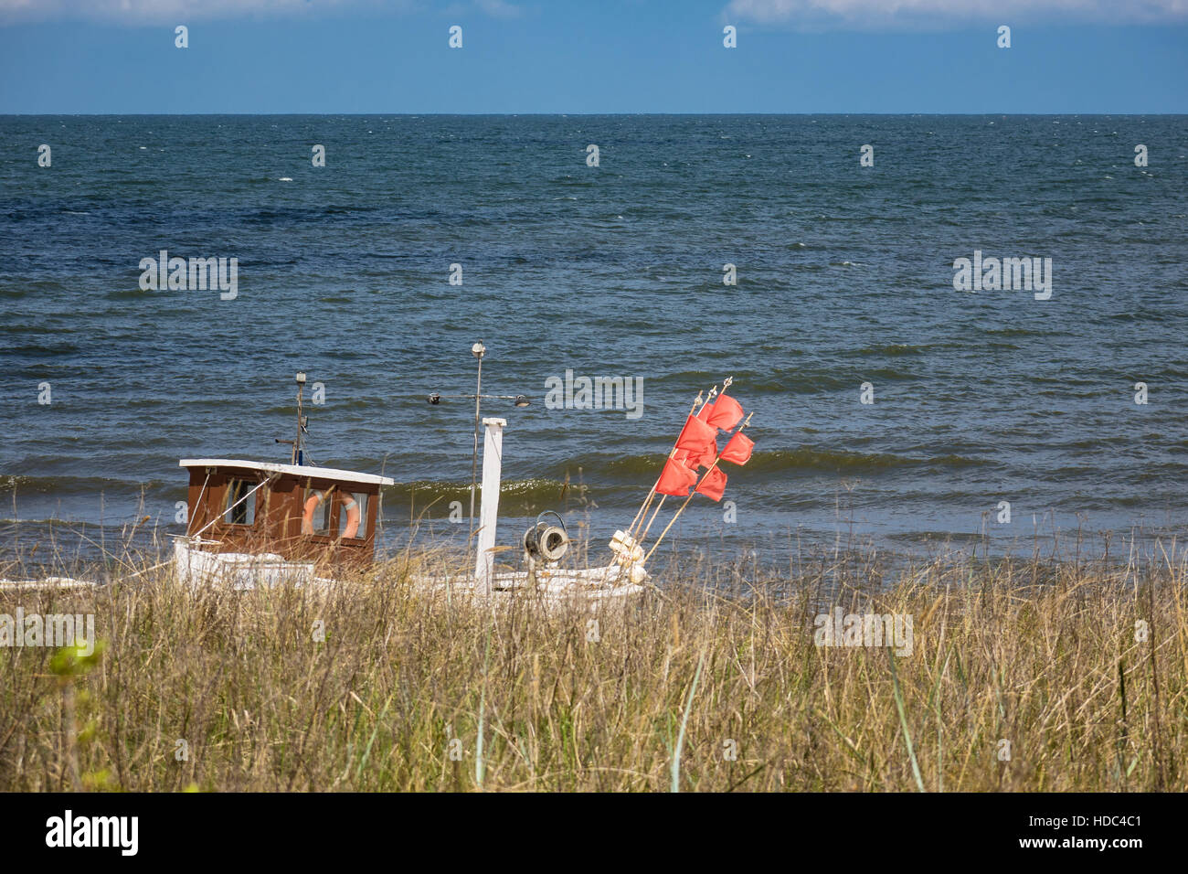 A fishing boat on shore of the Baltic Sea in Koserow, Germany Stock ...
